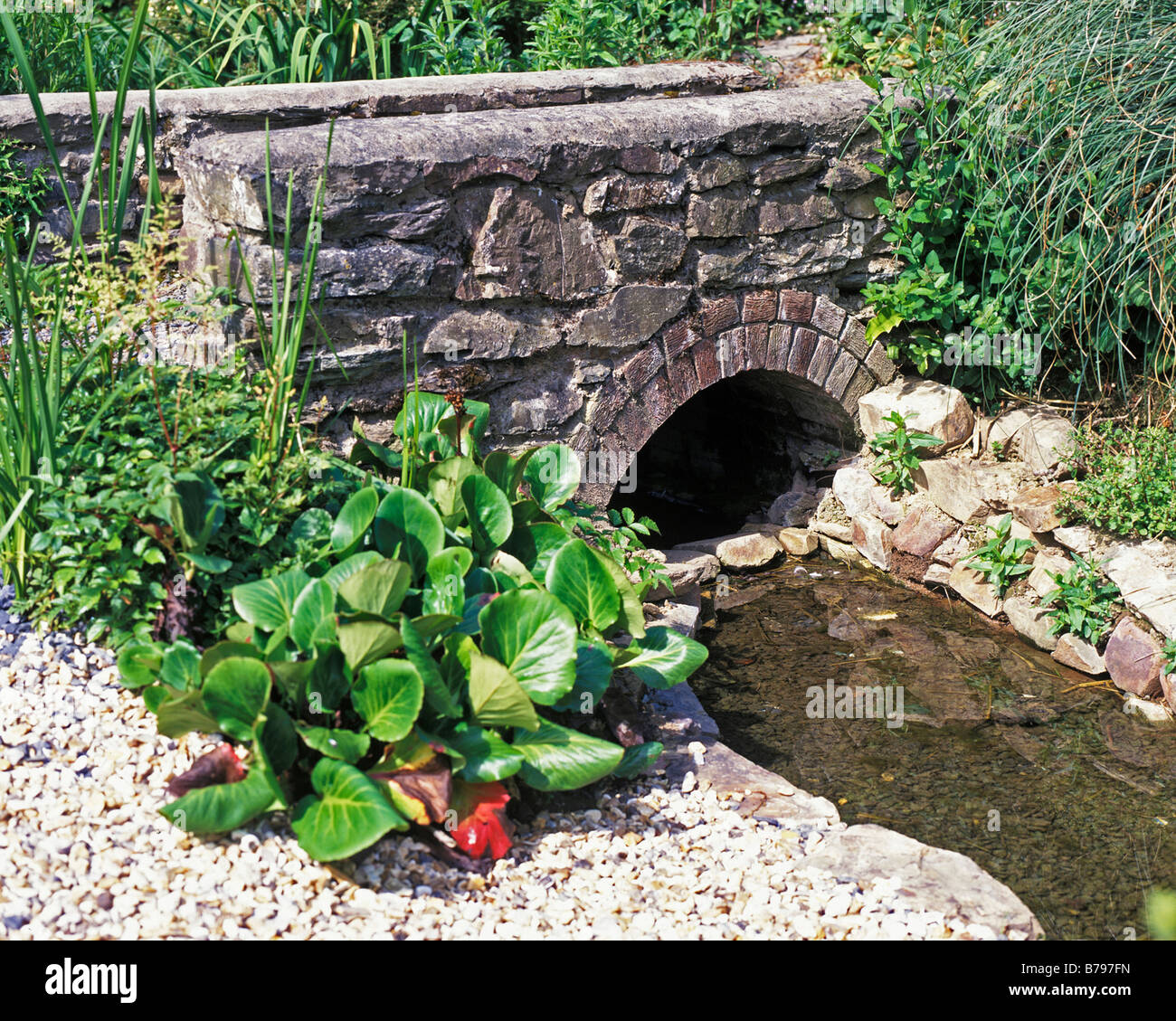 NATURAL STONE BRIDGE OVER GARDEN POND Stock Photo - Alamy