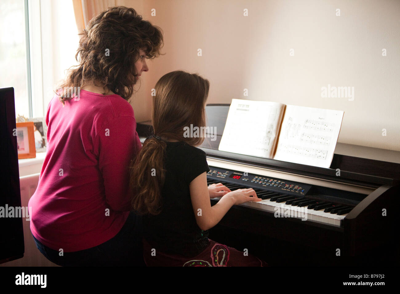 mother and daughter playing the electronic piano keyboard Stock Photo ...