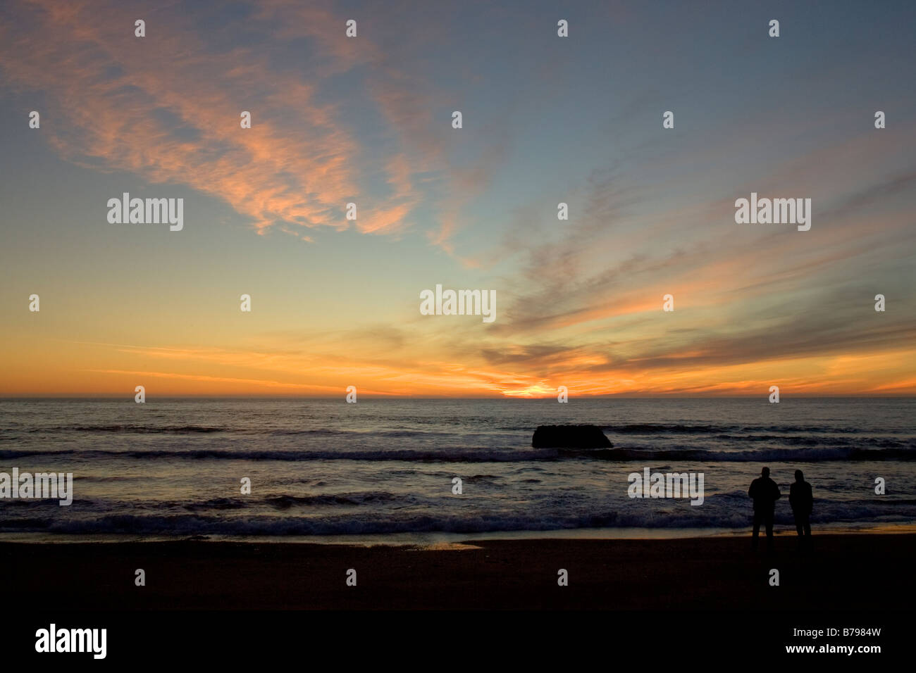 Two People Watching the Sunset Stock Photo - Alamy