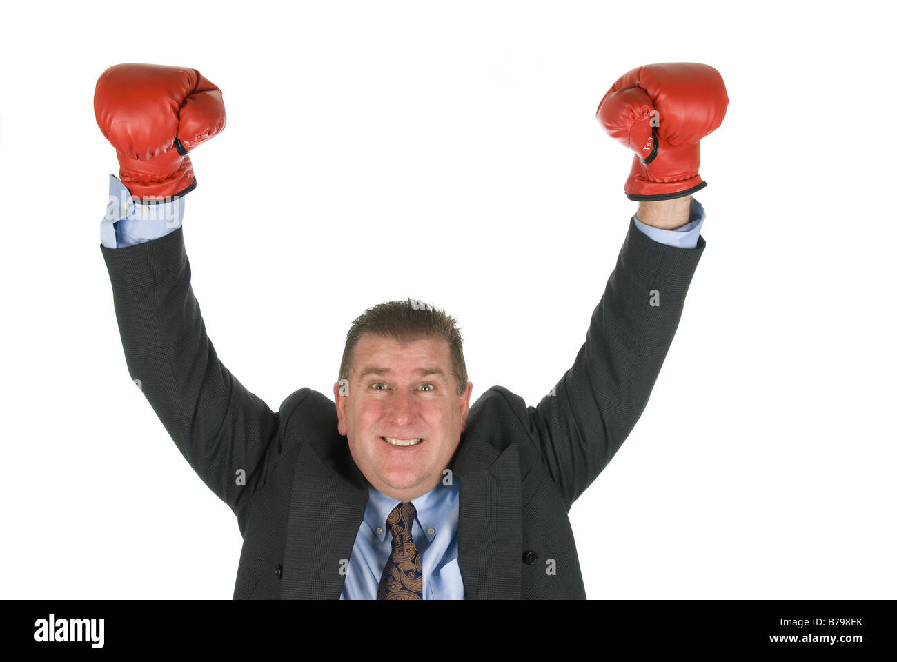 A businessman raises his arms in victory during contract negotiations ...