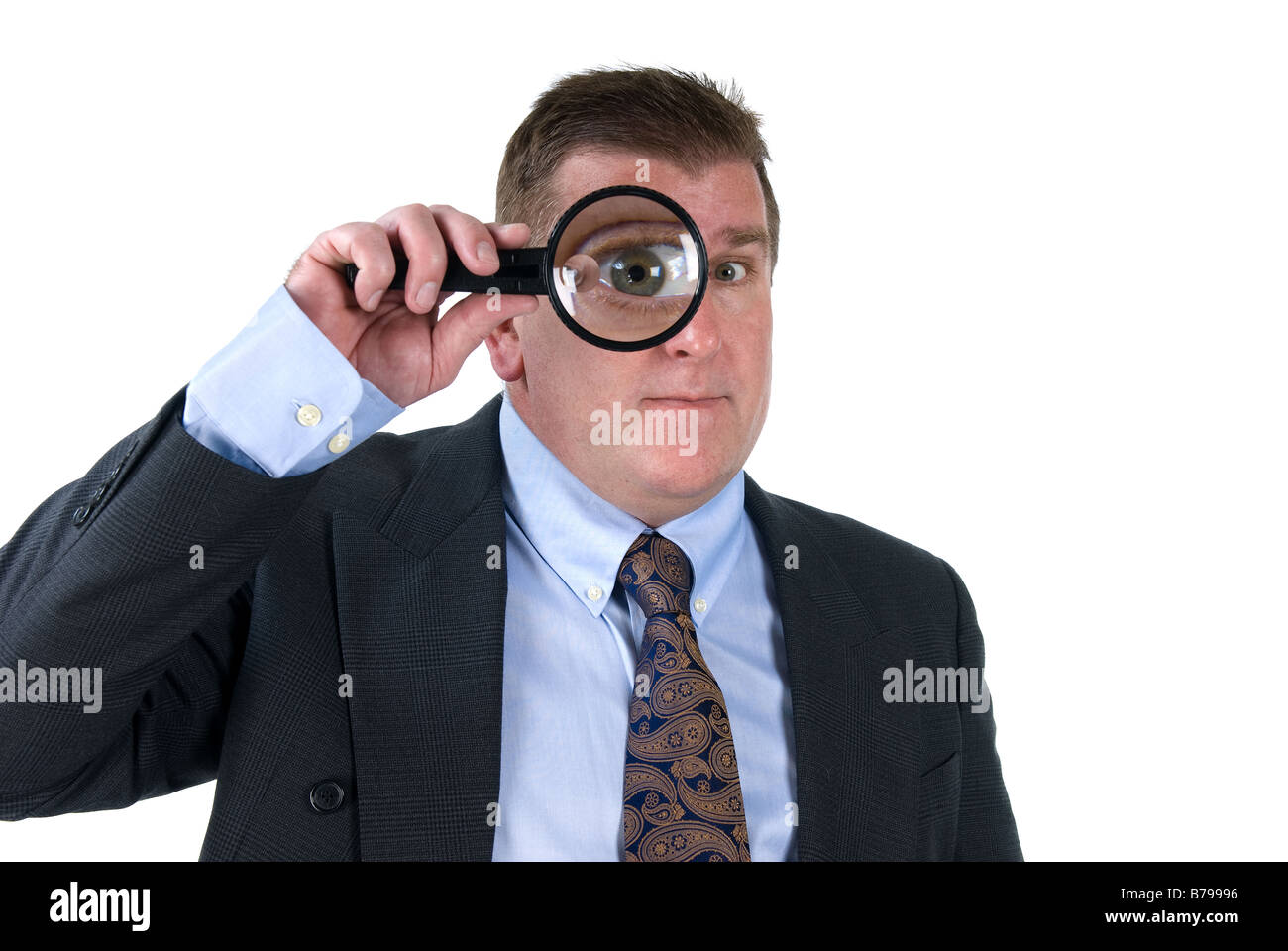 A man inspects things with his magnifying glass which shows his ...