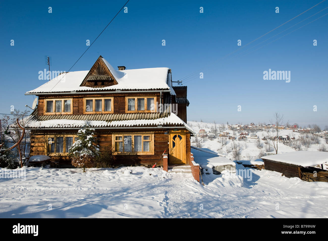 Snow covered village of Bukowina Tatrzanska and typical wooden ...