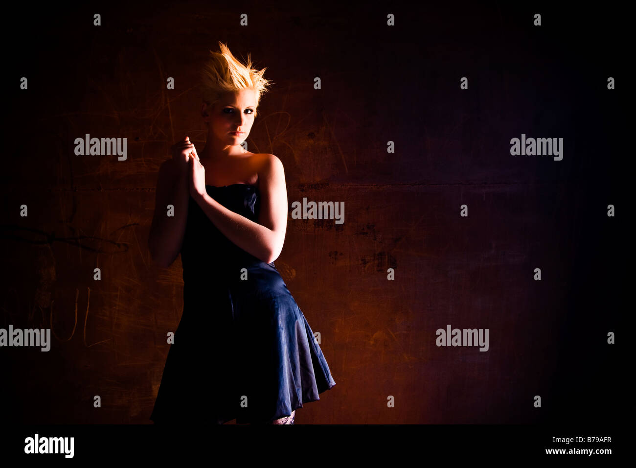 Young beautiful woman staring seriously at camera Stock Photo - Alamy