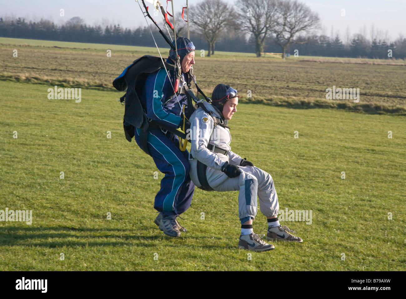 TANDEM PARACHUTING IN ENGLAND. A TANDEM PASSENGER STRAPPED TO AN ...