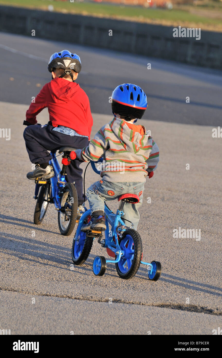 Two boys riding bikes hi-res stock photography and images - Alamy