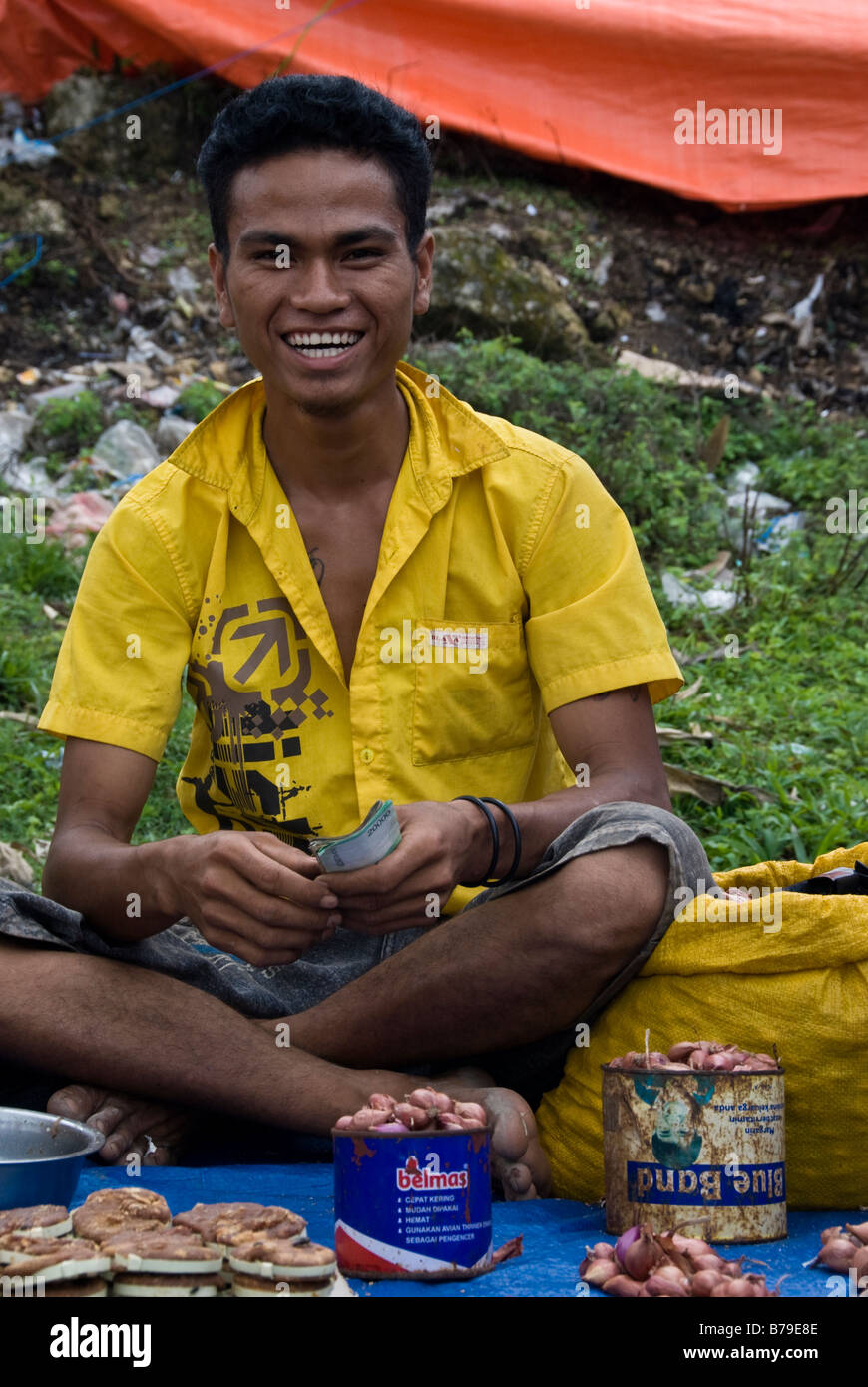 Smiling young Tetum man selling garlic in Kapan market, West Timor ...