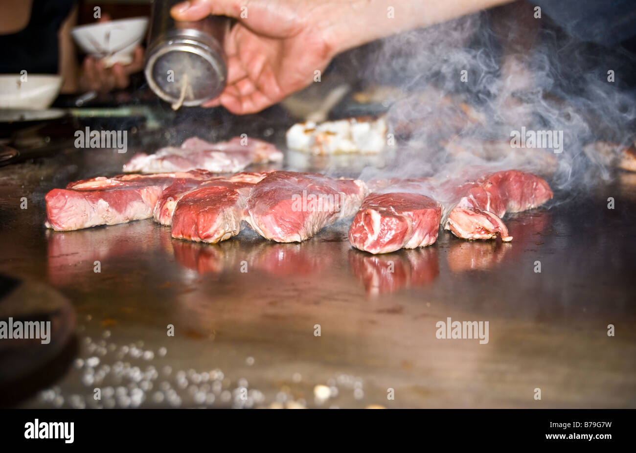 Grilling scotch fillets on the hot plate in the Japanese teppanyaki ...