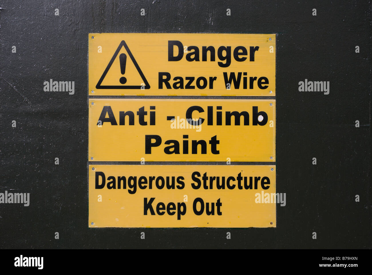 british yellow and black sign on exterior of a building warning of ...