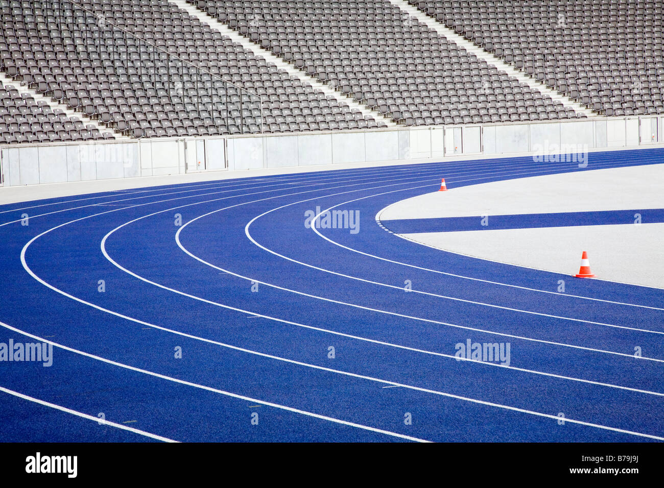 Running track in empty stadium blue track against background of empty ...