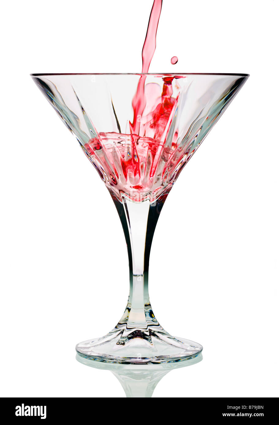 Pouring red cocktail into glass isolated against white background Stock ...