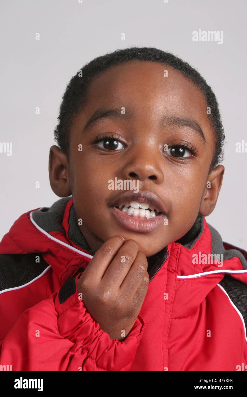 Cute african american boy looking at camera and jestering with his hand ...