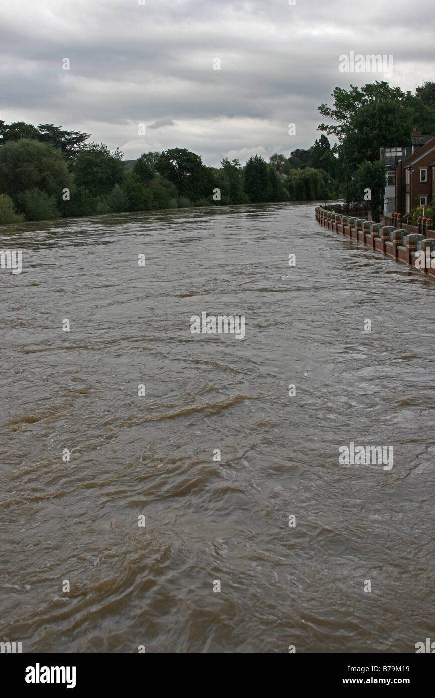 Flood defences protecting houses against a flooded River Wye at ...