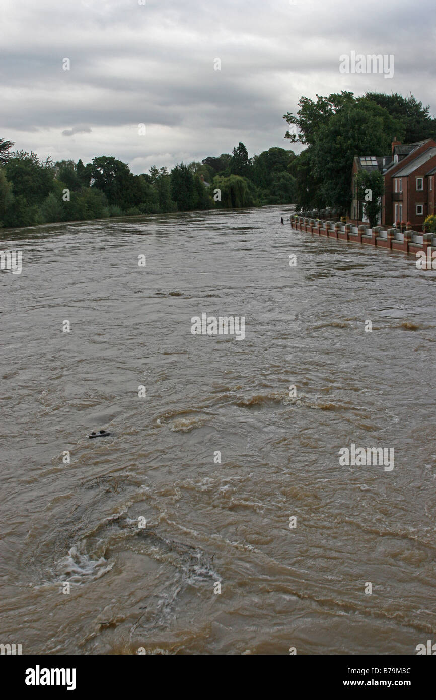 Flood defences protecting houses against a flooded River Wye at ...