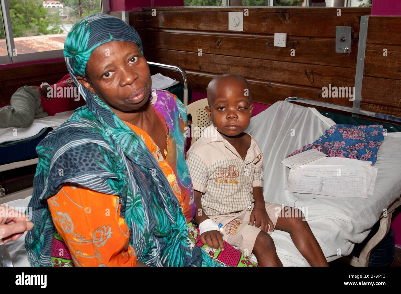 Child patient with Burkitts lymphoma cancer and mother sitting on bed ...