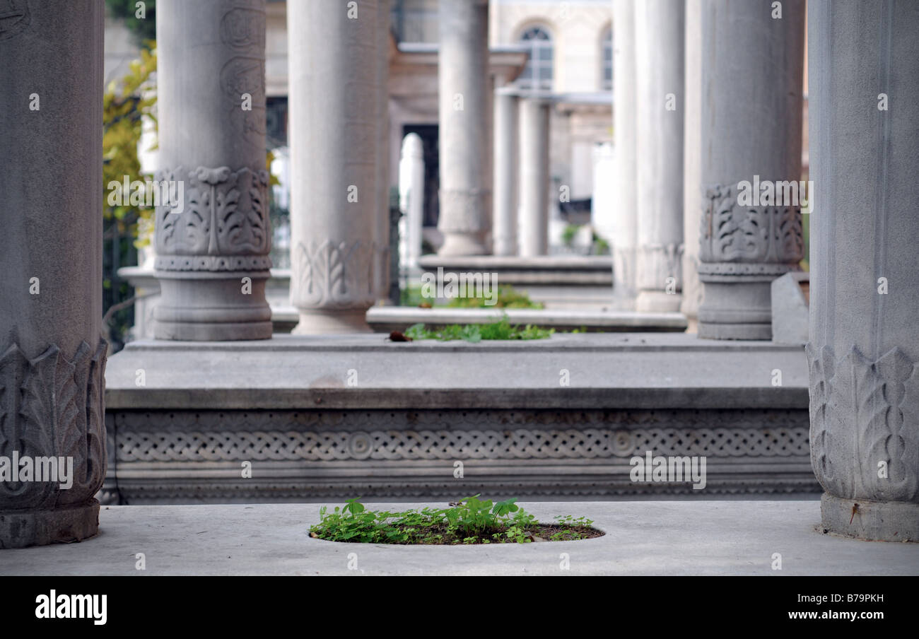 Ornate pillars adorn the tombstones in a historic graveyard- the burial ...