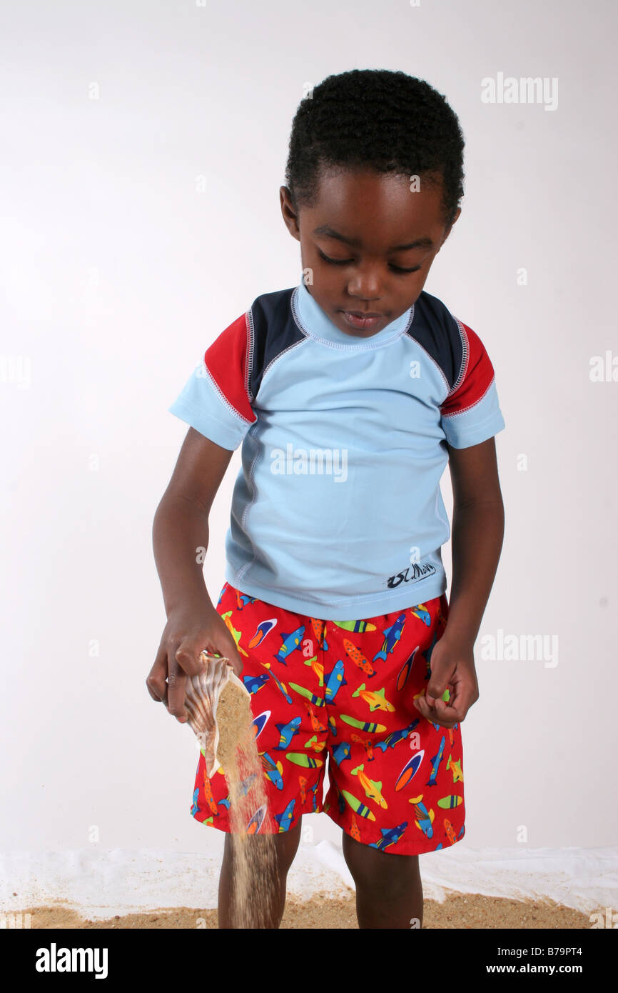 Boy holding seashell hi-res stock photography and images - Alamy