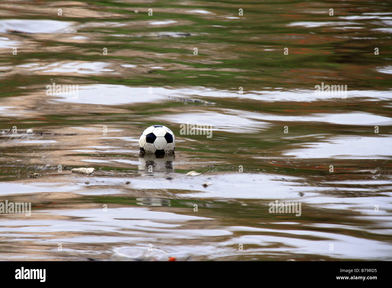 one lost ball floating down river Stock Photo - Alamy