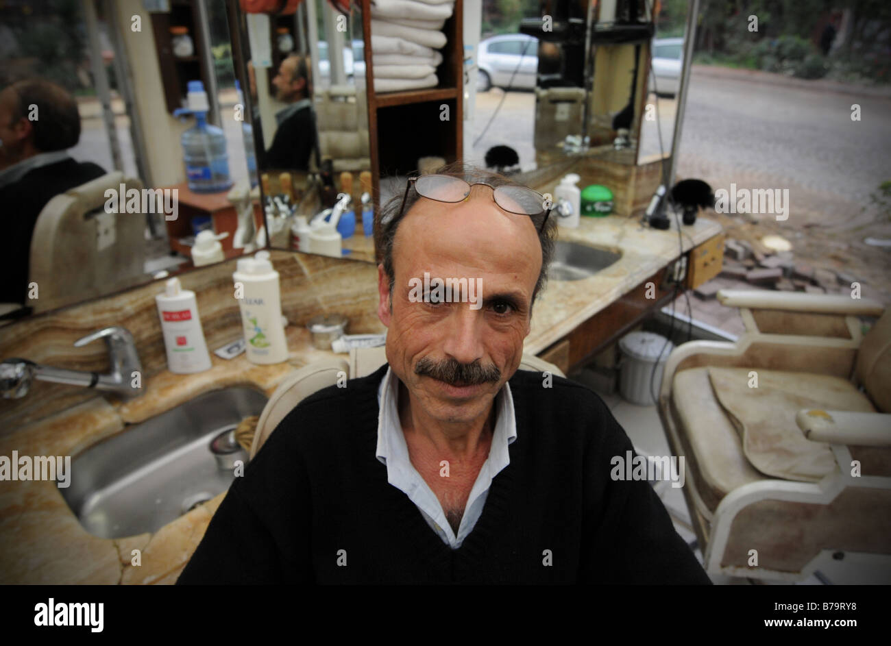 A traditional Turkish barber (Berber) sits awaiting morning business at ...