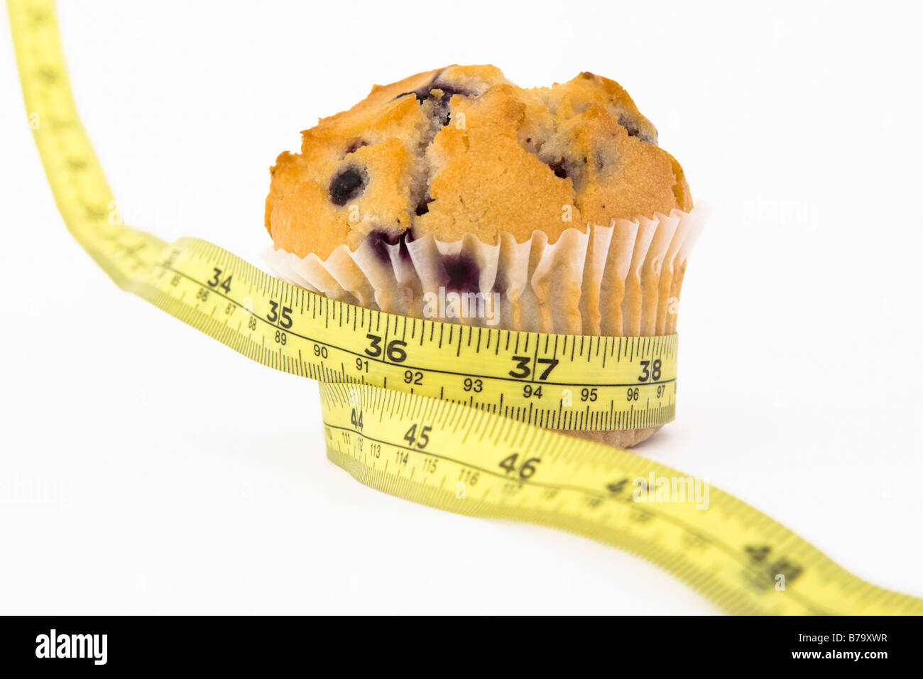 A muffin cake with a tape measure wrapped around Stock Photo - Alamy