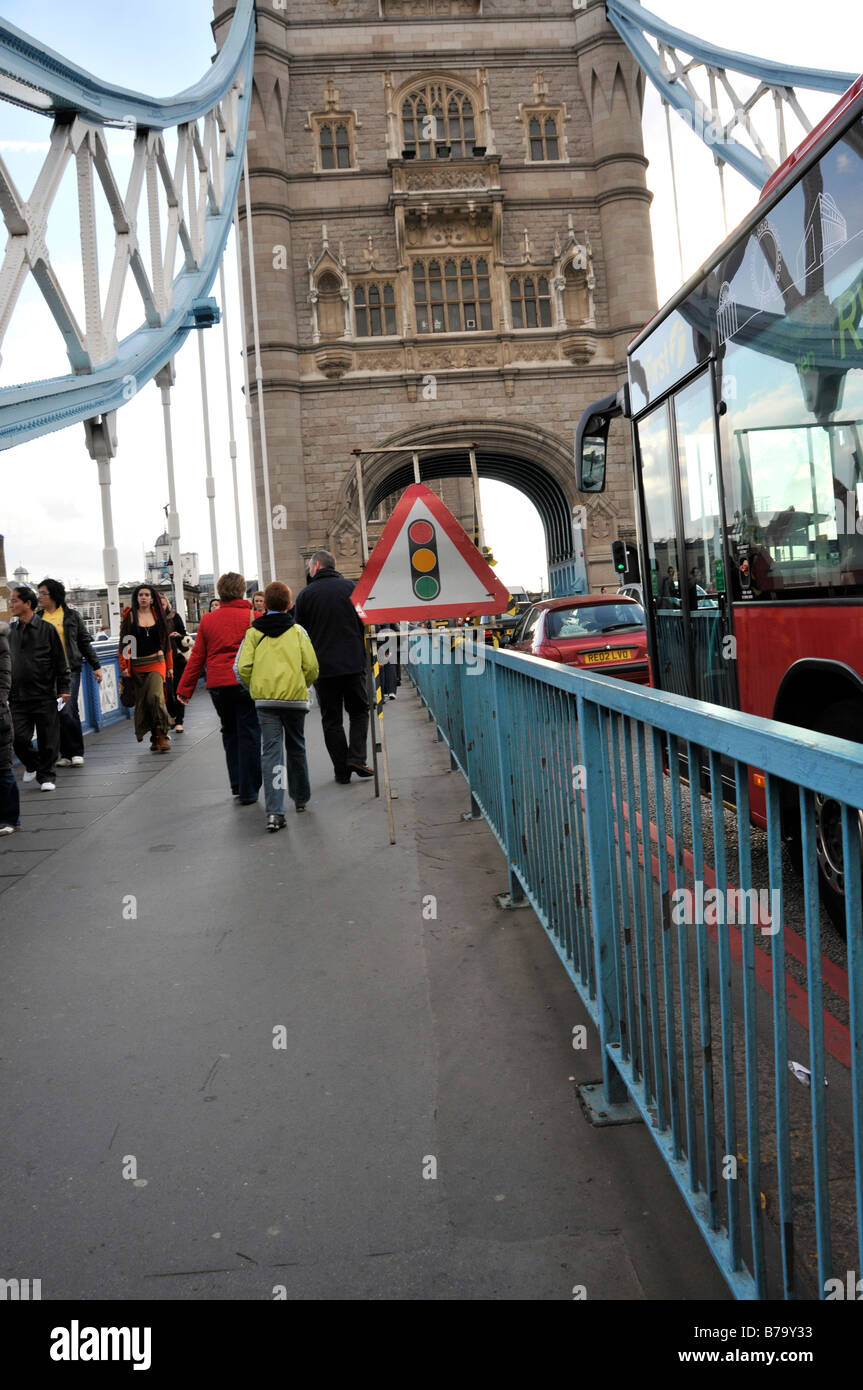 Commuters walking across tower bridge London England UK United Kingdom ...