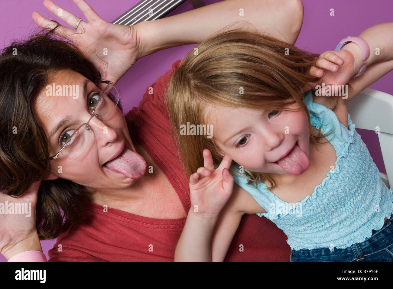 Mother and her young daughter making faces at the camera MODEL RELEASED ...