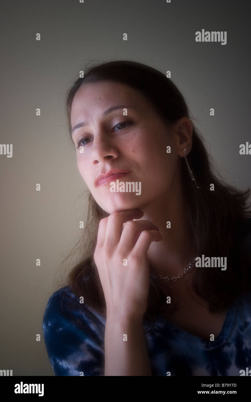 Woman resting head on hand and moody hi-res stock photography and ...