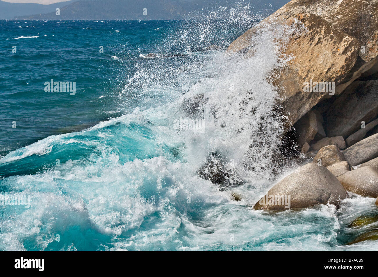 A rocky shoreline and breaking waves on the east shore of Lake Tahoe on ...