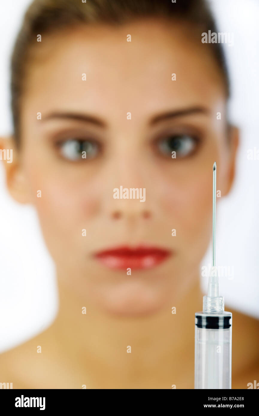 Young woman and an injection needle Stock Photo - Alamy