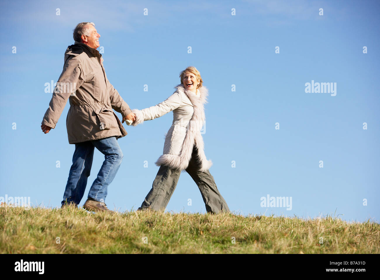 Senior Man Pulling His Wife By The Hand Stock Photo - Alamy