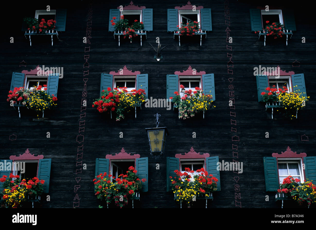 Alpine-style window boxes overflowing with colourful flowers grace the ...