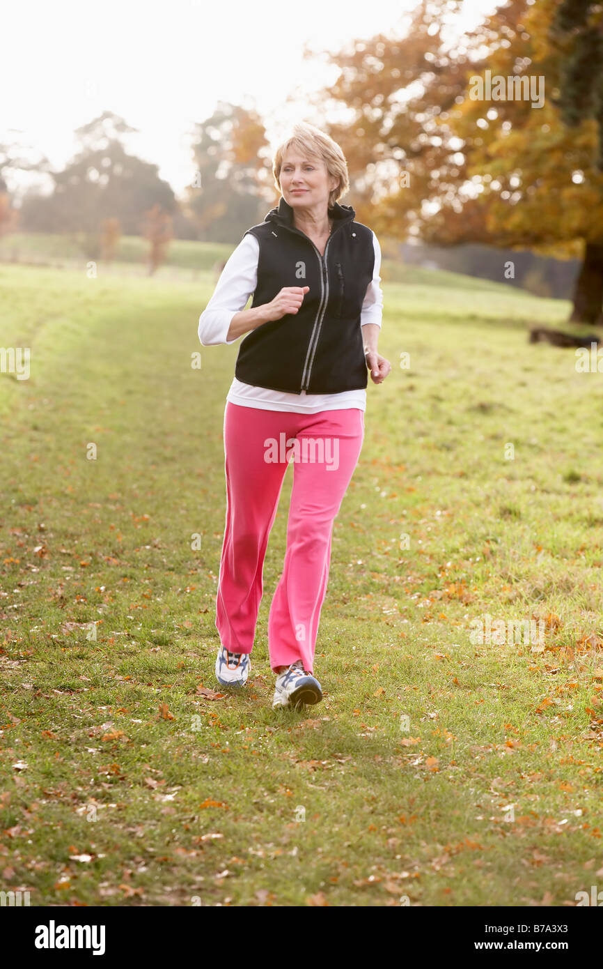 Senior Woman Power Walking In The Park Stock Photo - Alamy