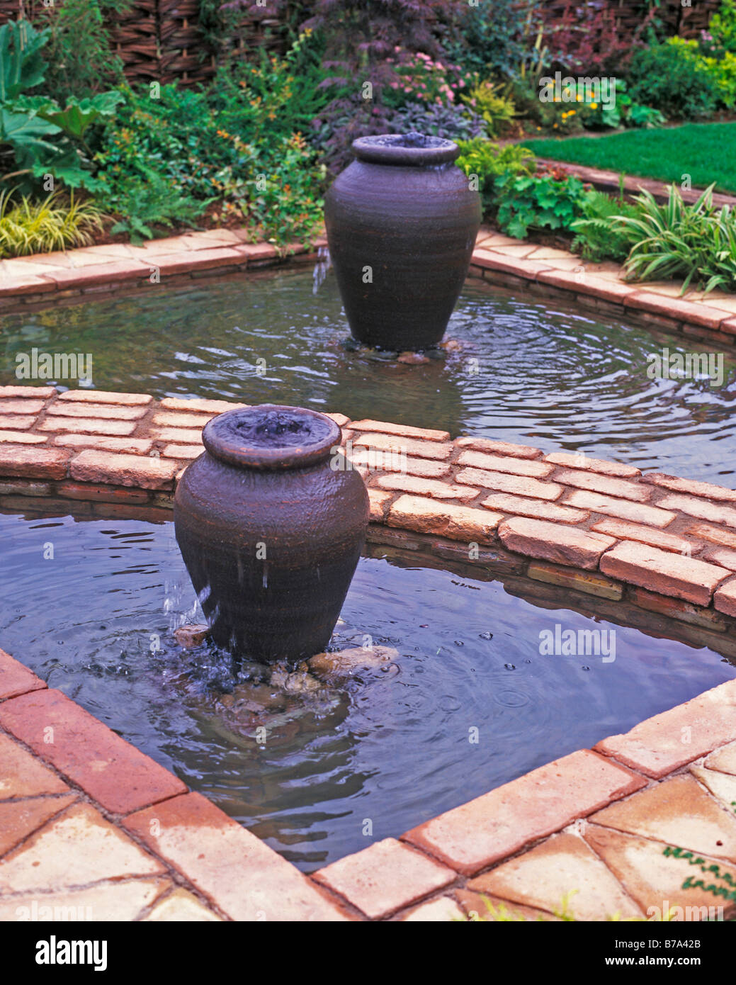 FOUNTAINS BASED ON OVERFLOWING URNS IN POND Stock Photo - Alamy
