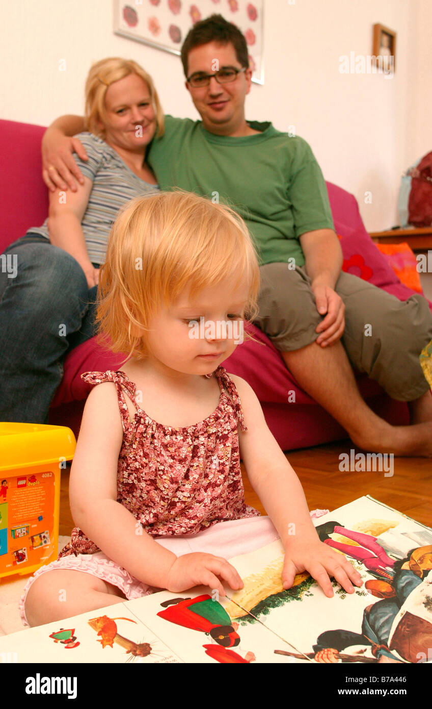 Proud parents looking at their child Stock Photo - Alamy
