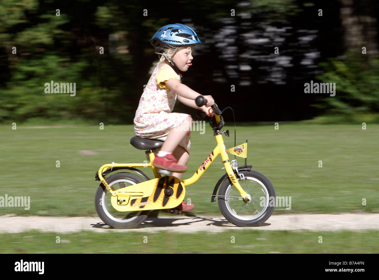 Child riding bicycle side view helmet hi-res stock photography and ...