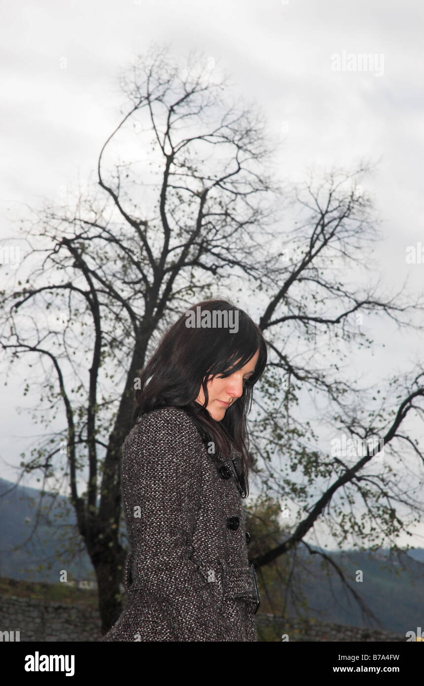 Portrait of a young woman outdoors looking down Stock Photo - Alamy