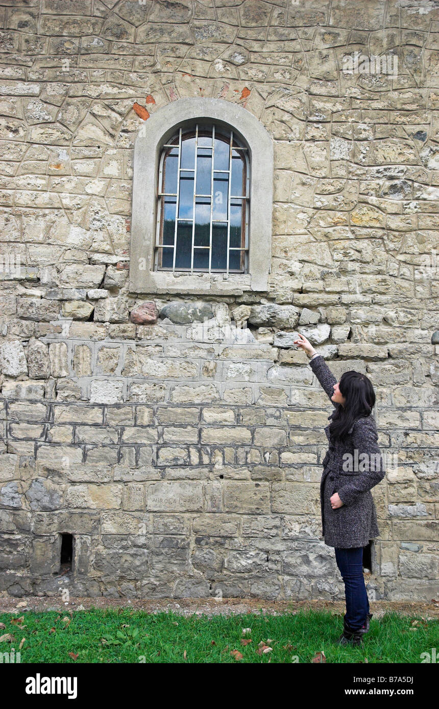 Young woman pointing at window Stock Photo - Alamy