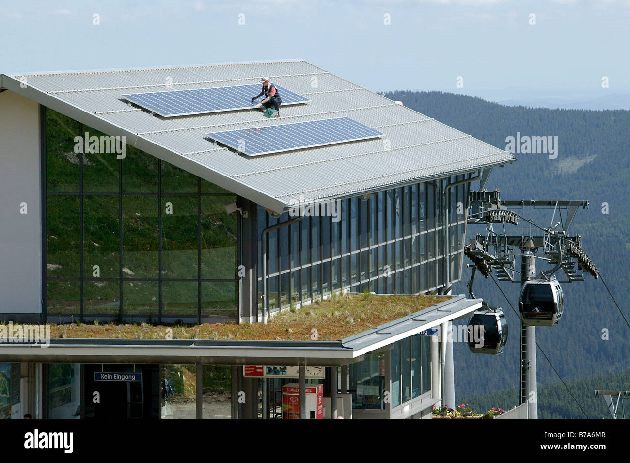 An employee of the Arber Mountain Railway inspecting the photovoltaic ...