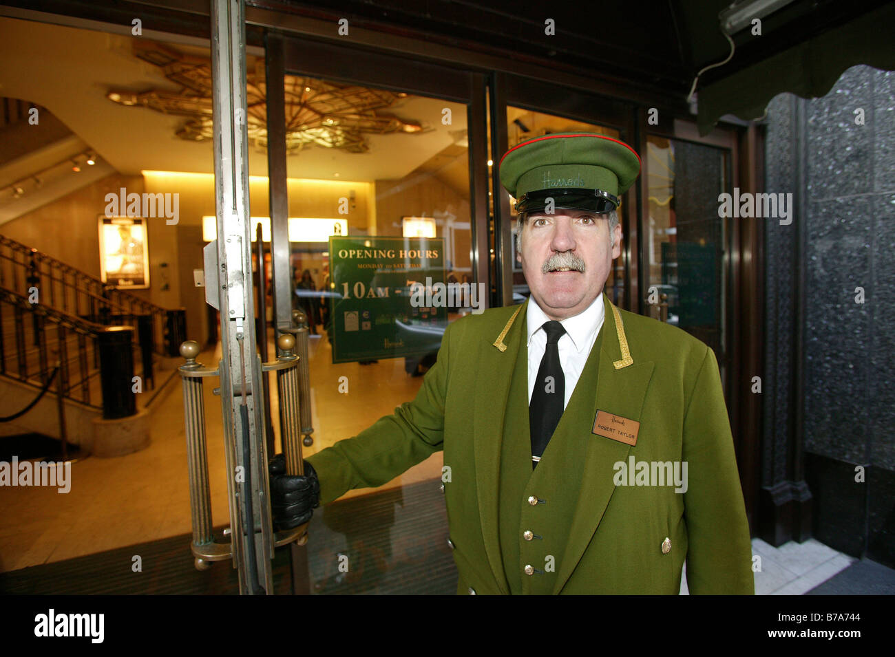 Doorman at the entrance of the Harrods department store in London ...