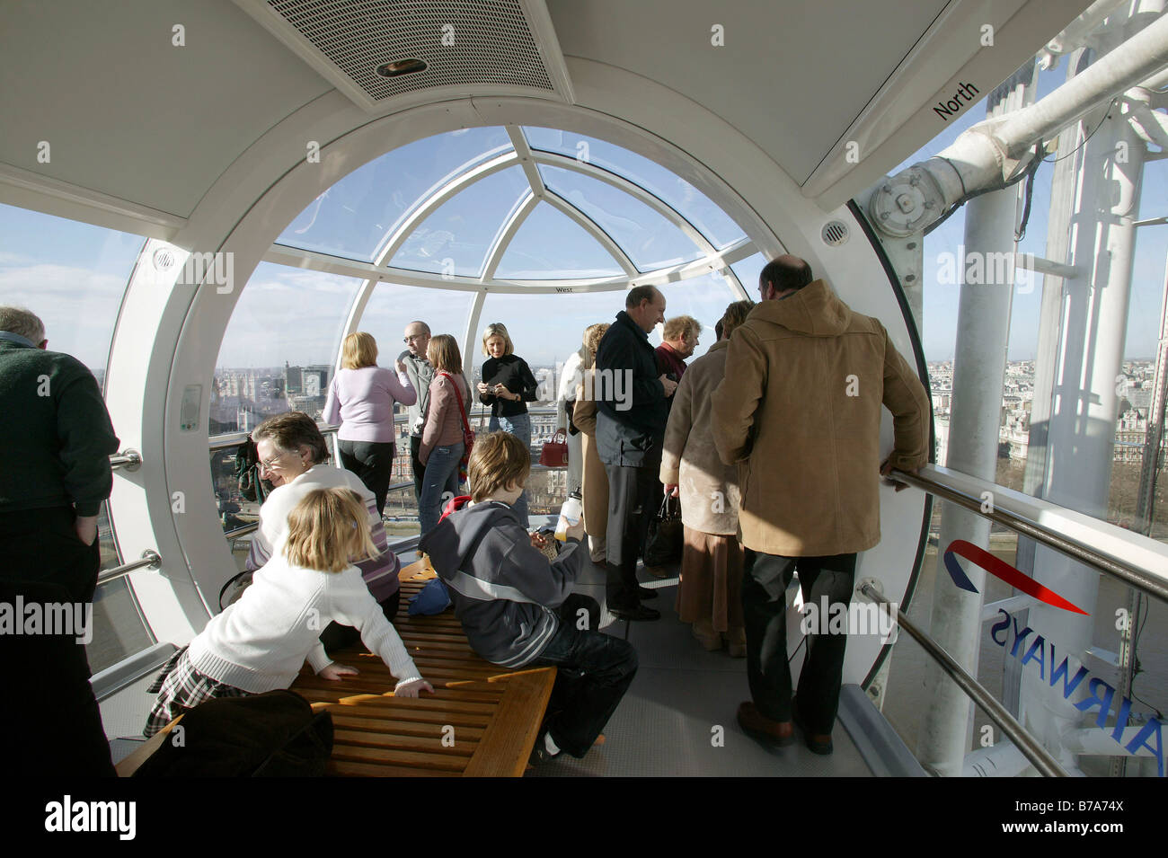Tourists in a cabin of the Millennium Wheel with view on London ...