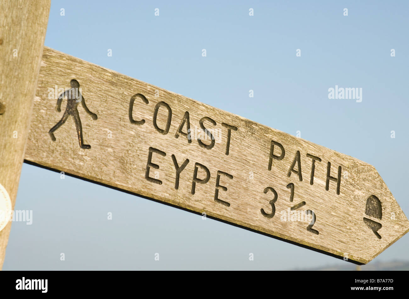 Wooden sign post showing pedestrian coastal path in Dorset Stock Photo ...