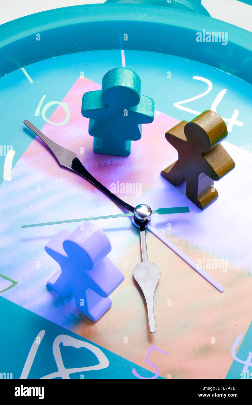 Wooden children figures on clock Stock Photo - Alamy