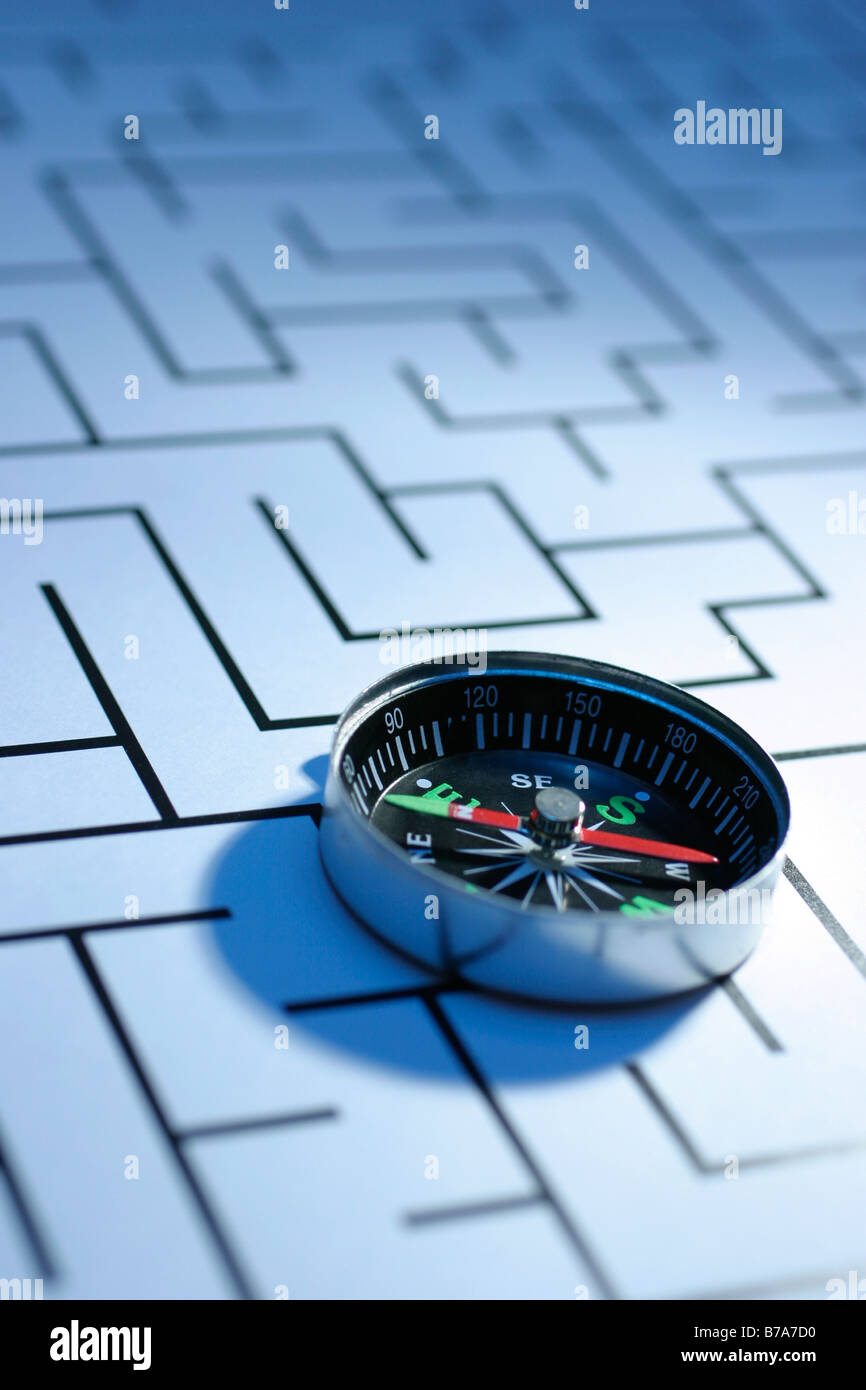Compass on maze Stock Photo - Alamy