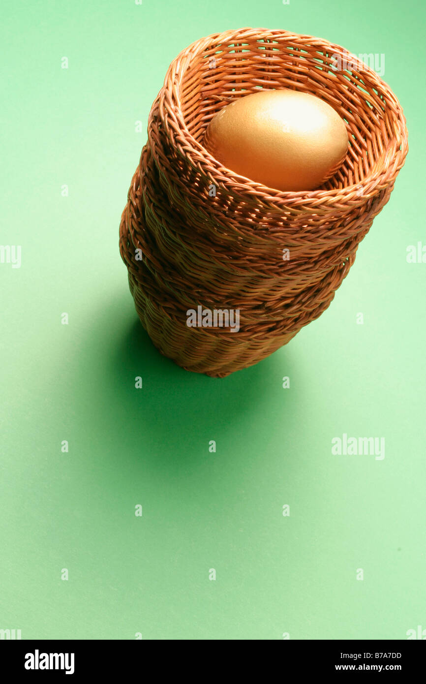 Stack of baskets with golden egg Stock Photo - Alamy