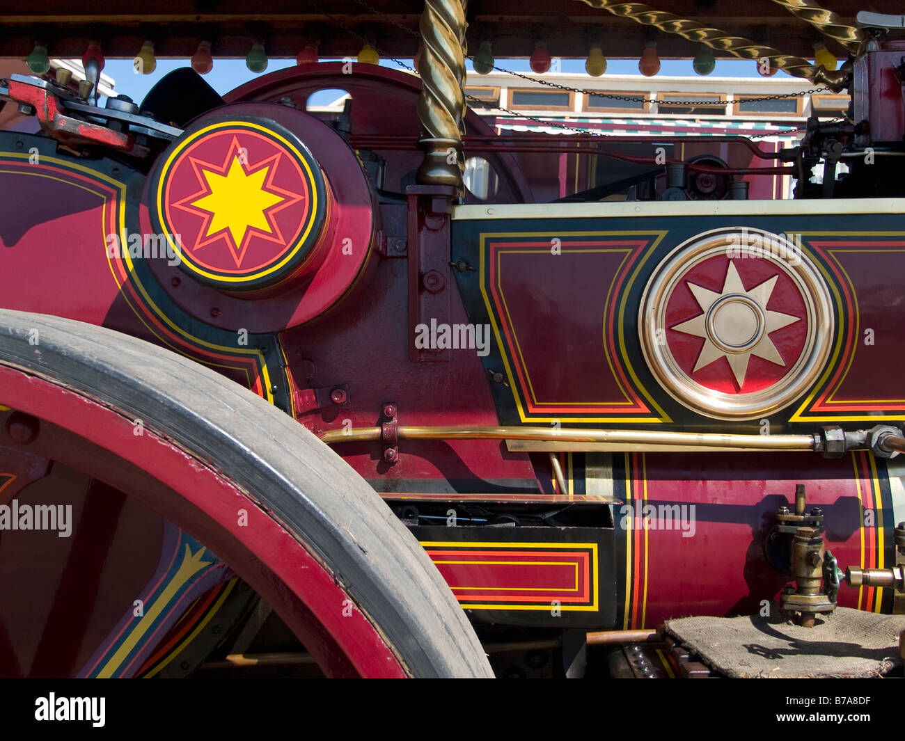 a detail of a traction engine wheel with its polished brass, star ...
