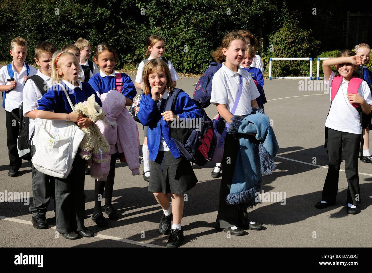 Group of primary children boys and girls in a school playground England ...