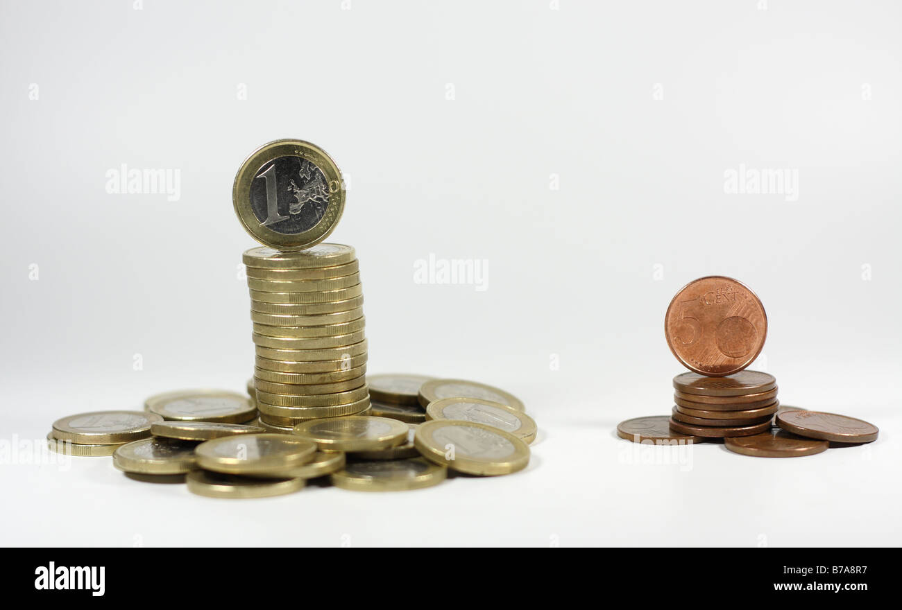 Two money towers with Euro coins, a small one and a big one Stock Photo ...