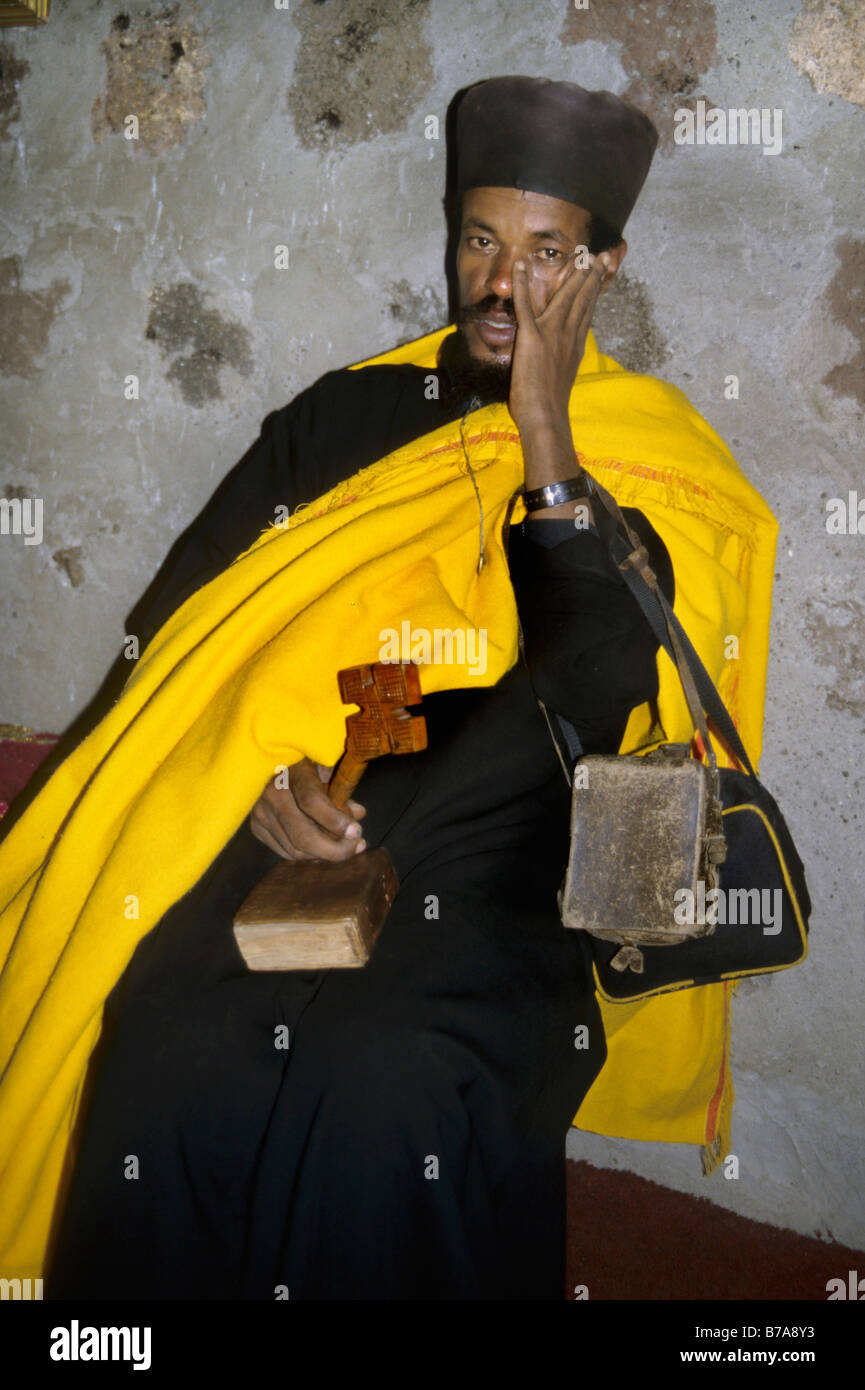 Coptic monk wearing black robes and bright yellow shawl Stock Photo - Alamy