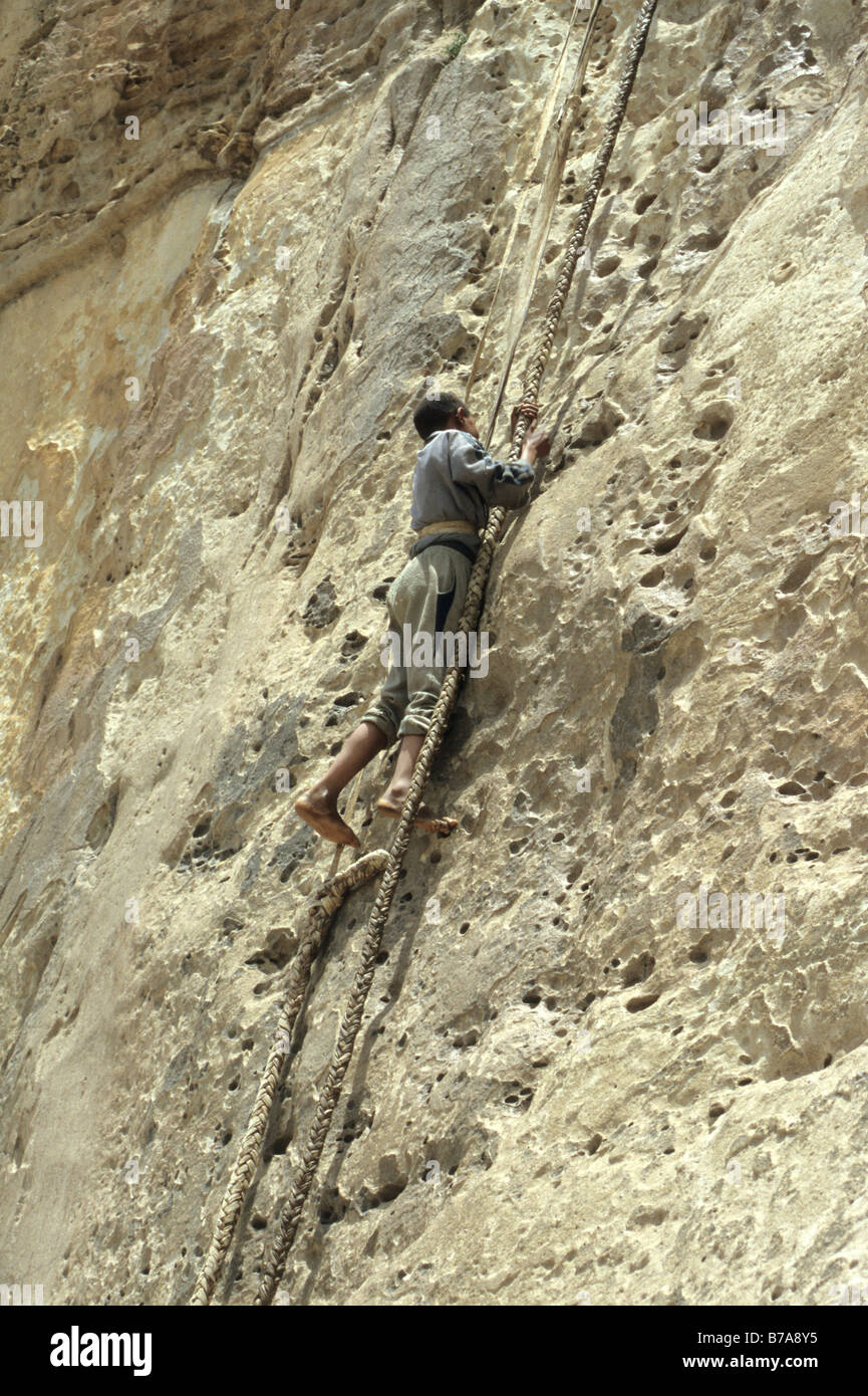 Pilgrim climbing a rope ladder to the Debre Damo cliff monastery Stock ...