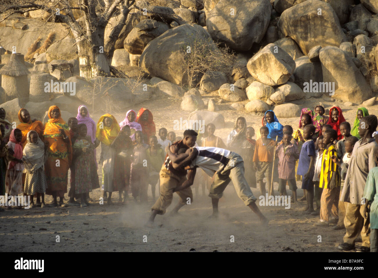 Two young Kau men fighting surrounded by a large group of spectators ...