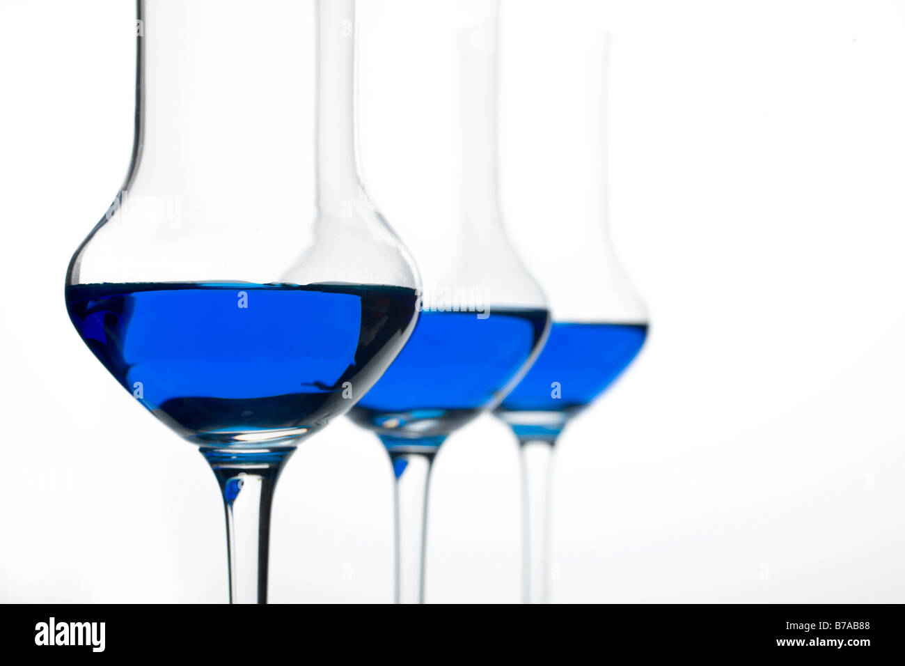 Blue liqueur in glasses Stock Photo - Alamy